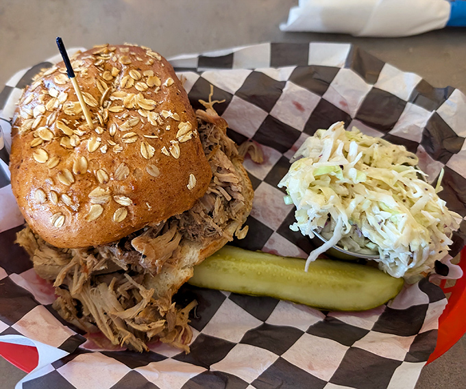 The pulled pork sandwich that launched a thousand road trips, topped with an oat-sprinkled bun that's doing some serious heavy lifting.
