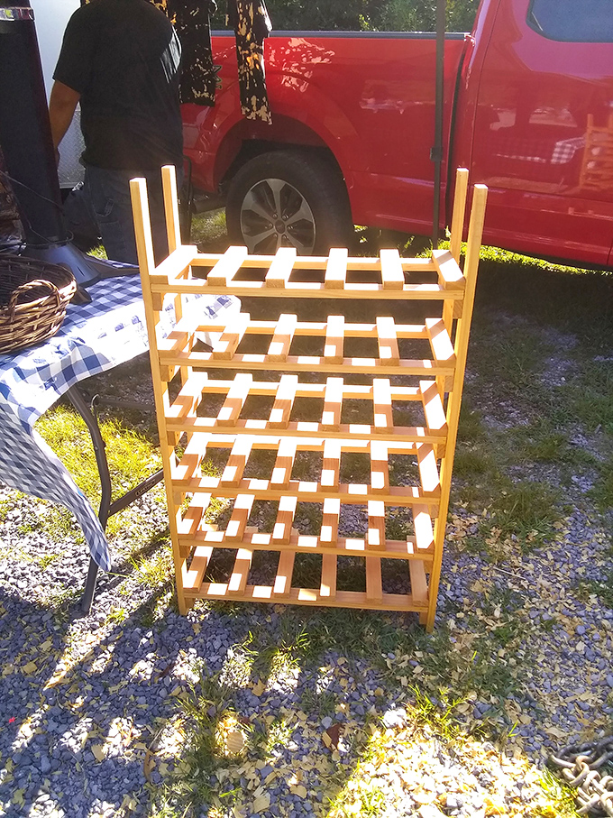 This handcrafted wine rack stands ready for duty, its simple wooden design a testament to form following function.