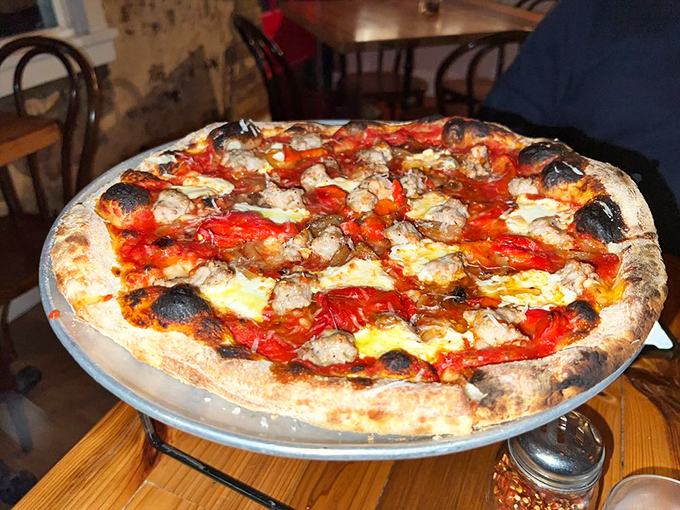 The sausage pie arrives like a work of art, with caramelized edges and that perfect balance of savory toppings that makes you forget to take photos first.