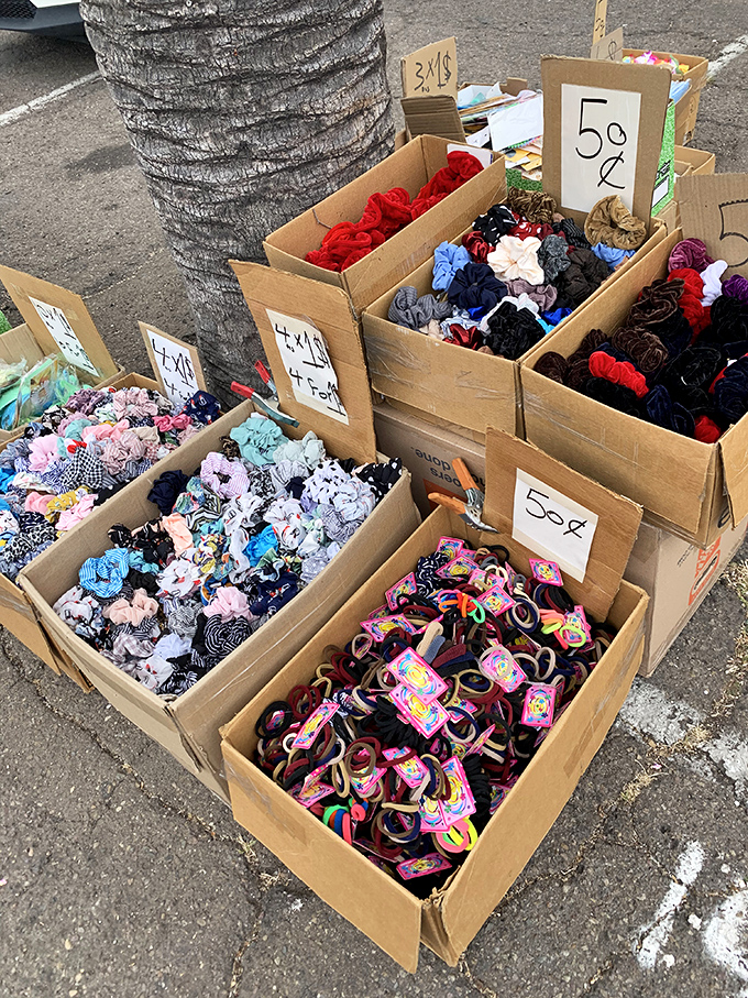 Hair accessories sorted by color in cardboard boxes represent the swap meet aesthetic at its most beautifully practical.