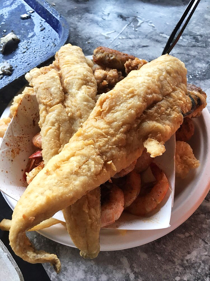 This isn't just fried seafood—it's edible Southern poetry. Golden fish fillets and shrimp sharing a plate like old friends at a reunion.