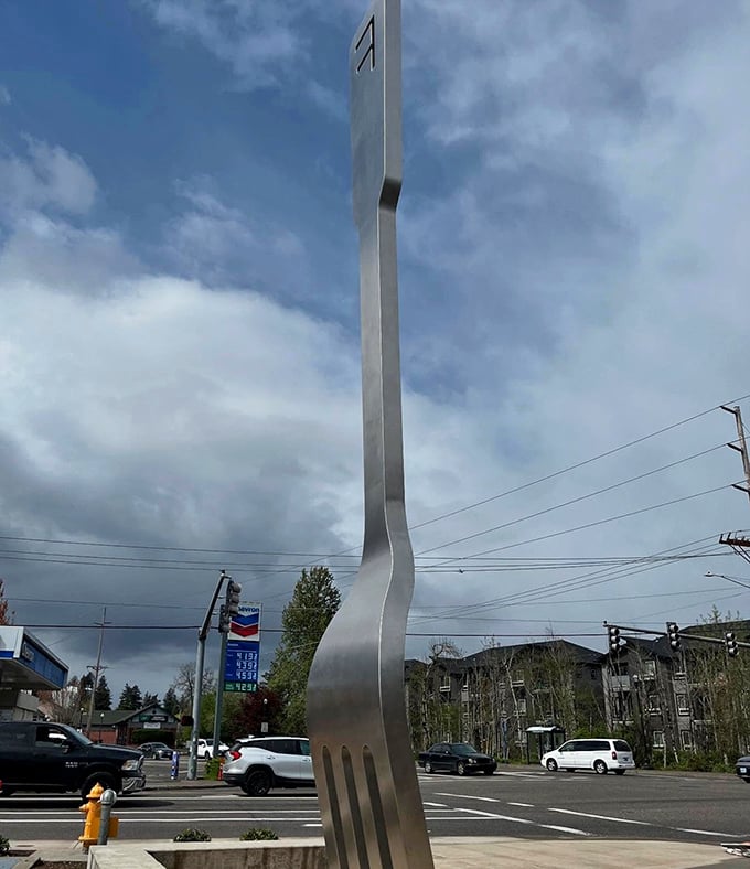 The fork's elegant handle stretches toward the clouds, a stainless steel exclamation point announcing "Eat here!" to passing motorists.