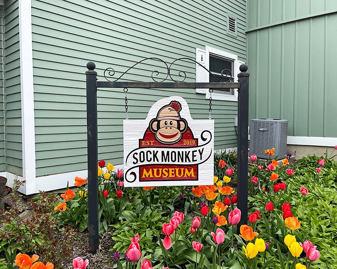 Surrounded by spring tulips, the museum's charming sign welcomes visitors with a bespectacled monkey mascot who looks ready for adventure.