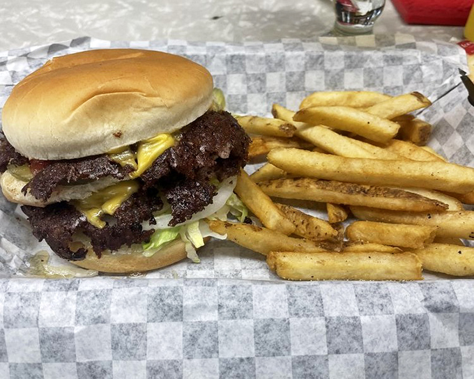 The smash burger and fries arrive on checkered paper, a delicious reminder that the best meals don't need fancy plates or garnishes.