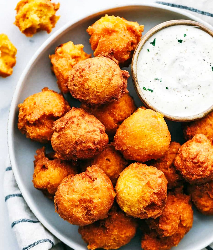 Golden orbs of cornmeal perfection! These hush puppies are the kind of simple pleasure that makes you question why you'd eat anything else.