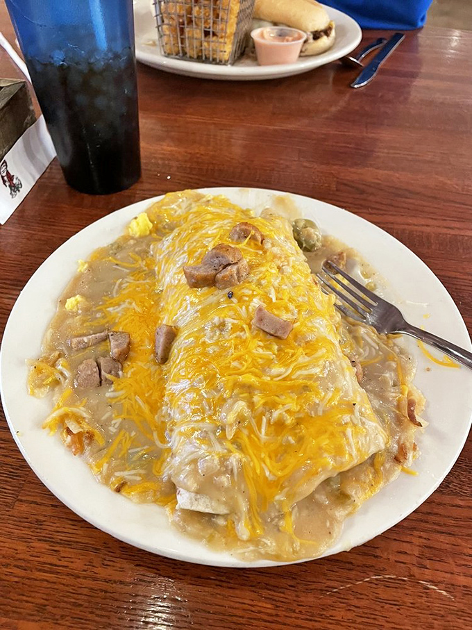 Behold the smothered burrito&mdash;where cheese and gravy unite in a glorious pact to ensure no fork returns to the table clean.