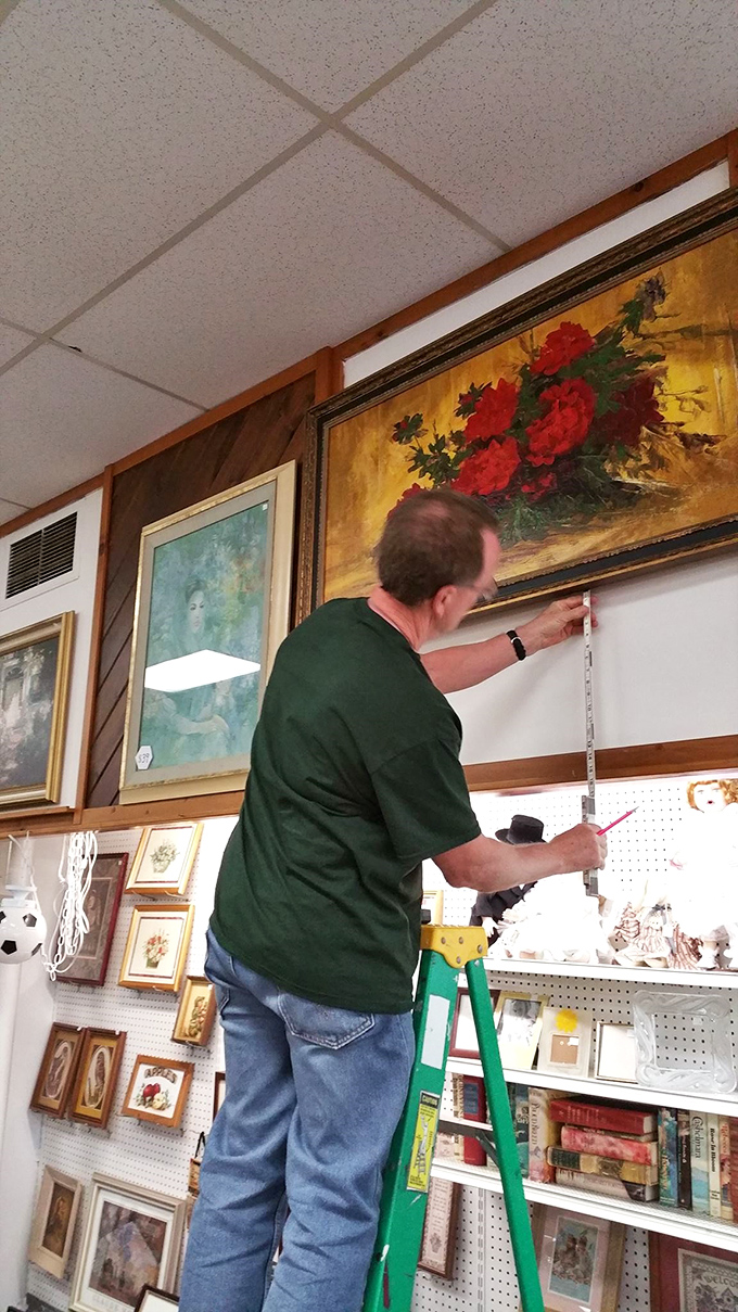 The unsung heroes of thrift stores—staff members who transform chaos into order. This careful measuring ensures your next wall art will hang perfectly level.
