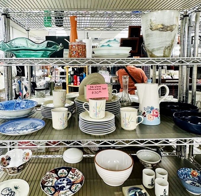 Dinnerware dreams stacked high on metal shelves. Someone's wedding registry rejects become your dining table's new statement pieces at prices that'll make you smile.