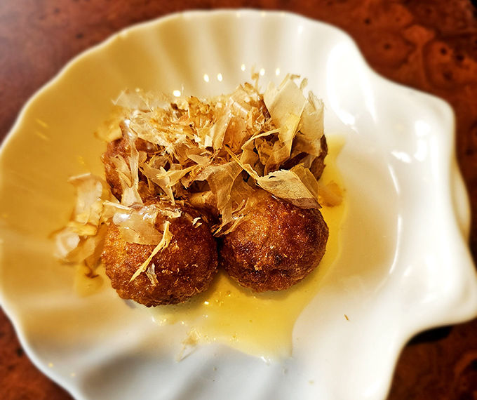 Golden takoyaki spheres topped with dancing bonito flakes &ndash; pure Japanese comfort food poetry.