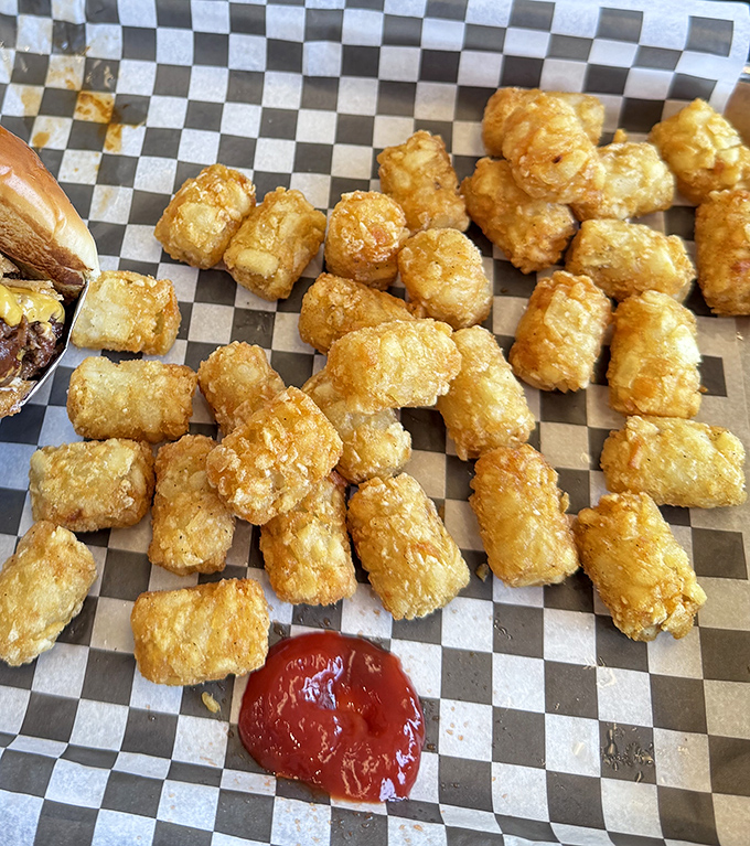 Golden tater tots: childhood nostalgia in crispy form. These perfectly fried potato nuggets make a compelling case for ordering a second basket.