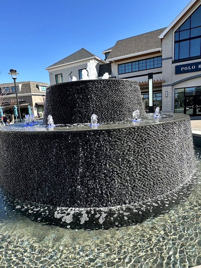 This tiered fountain isn't just decorative—it's where shoppers toss coins and wish for additional closet space after their outlet haul.