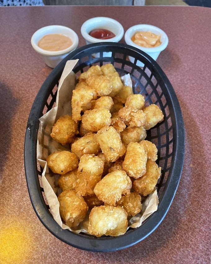 The tots trinity: golden-brown perfection with dipping sauces standing by. Like the Three Tenors of comfort food, but crunchier. 
