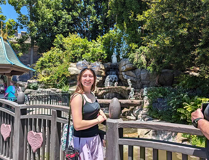 A smiling visitor creates her own happily-ever-after moment near the castle grounds, collecting memories instead of souvenirs.