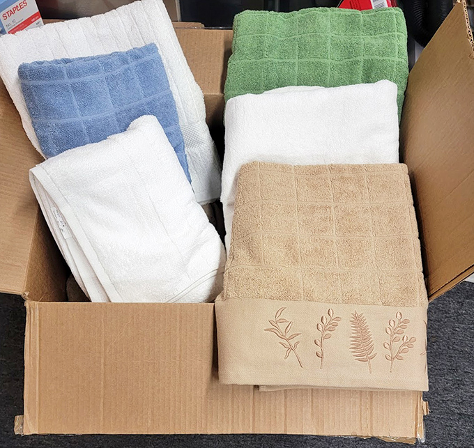 Fresh linens and towels neatly boxed—because nothing says "adulting" quite like getting excited about finding quality terry cloth at thrift store prices.