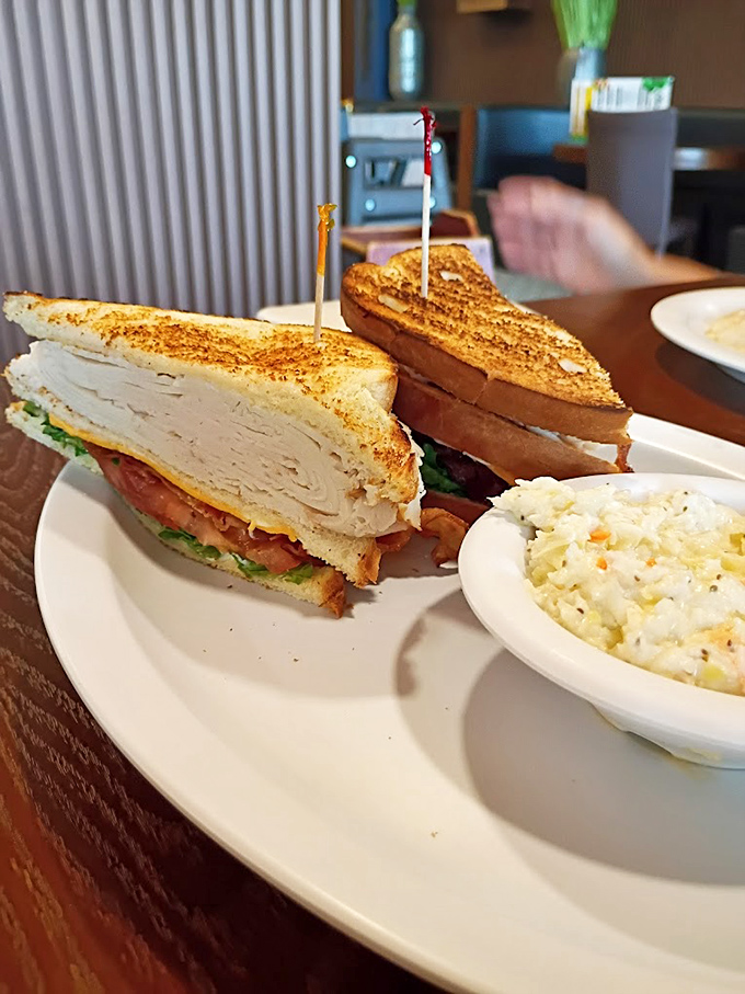 A club sandwich that towers like Indiana's ambitions, with coleslaw that doesn't know it's supposed to be a mere side dish.