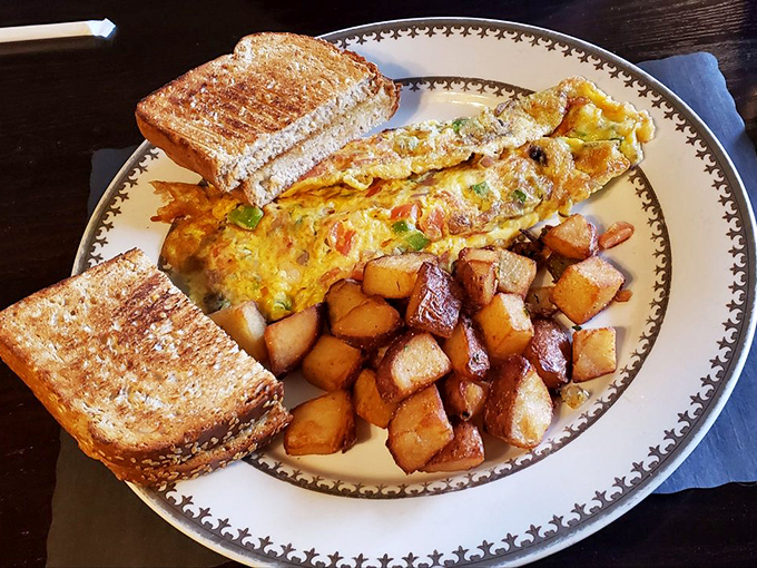 An omelet that's practically bursting with veggies, flanked by perfectly golden home fries and toast. Breakfast doesn't get more honest than this.