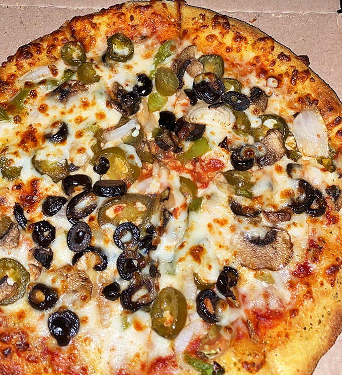 The veggie pizza that makes carnivores do a double-take. Black olives and mushrooms playing nicely together on a bed of melted cheese.