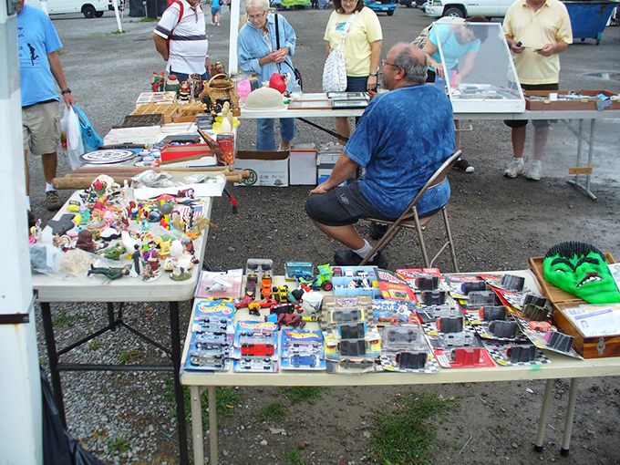 The vendor holds court from his folding chair, surrounded by decades of collectibles and the stories that come free with purchase.