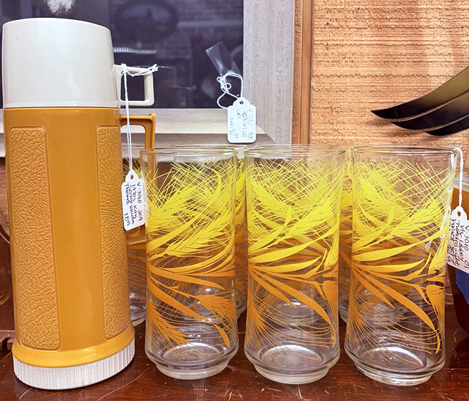 That mustard-yellow thermos and matching glasses set screams "family road trip" louder than your dad refusing to stop for bathroom breaks.