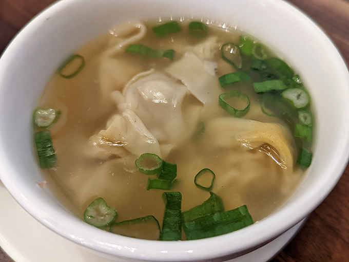 The famous wonton noodle soup in all its glory&mdash;dumplings floating like tasty little life rafts in a broth that deserves its own spa day.