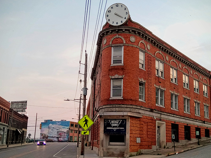 This historic corner building in Alton features distinctive architecture and a clock tower, representing the city's well-preserved downtown district.