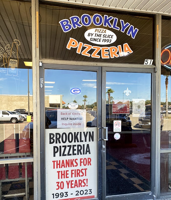 Brooklyn Pizzeria's glass doors reveal three decades of New York-style excellence folded into every magnificent Gulf Coast slice.