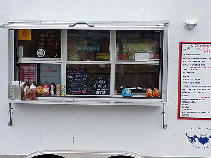 This mobile kitchen window reveals the organized chaos where legendary hot dogs are born daily.