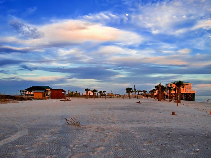 Sunset paints the sky while beach houses stand like colorful sentries guarding paradise.