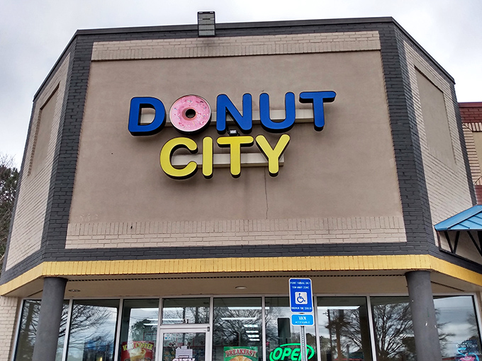 That cheerful pink donut in the logo tells you everything: this place takes fun seriously and donuts even more.