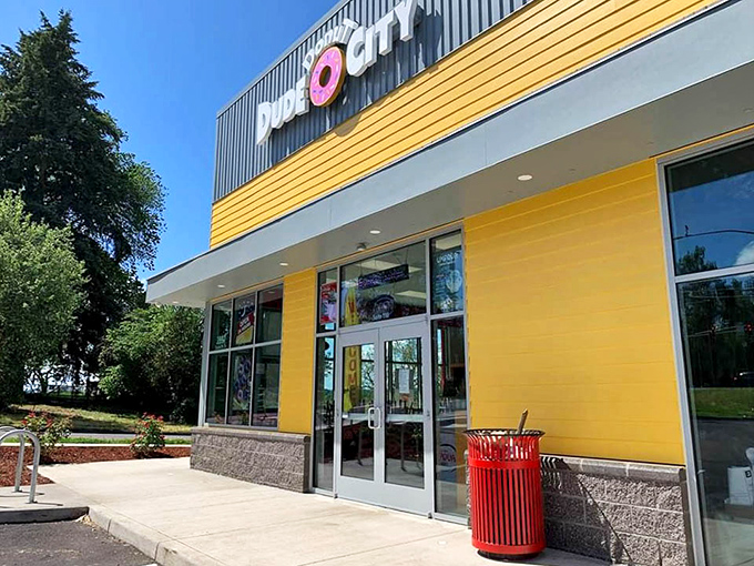 Dude Donut City's sunny yellow exterior matches the mood you'll have after visiting. Cheerful architecture for serious donut business.
