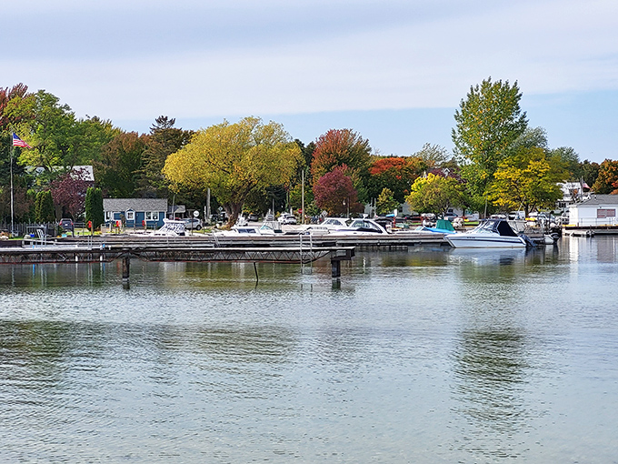 Fish Creek's harbor captures Door County magic, where sailboats dance against dramatic limestone cliffs behind.