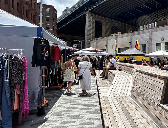 Flea Market magic under the Manhattan Bridge, where vintage clothing and urban views create the perfect New York shopping experience.