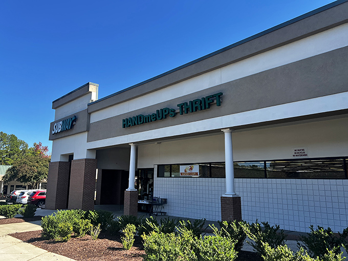 HandmeUPs Thrift nestles between everyday businesses, a humble facade hiding extraordinary bargains.