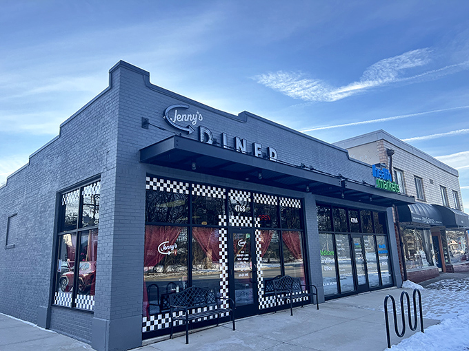 Jenny's Diner's sleek gray exterior and checkered trim hint at the classic American fare waiting inside.
