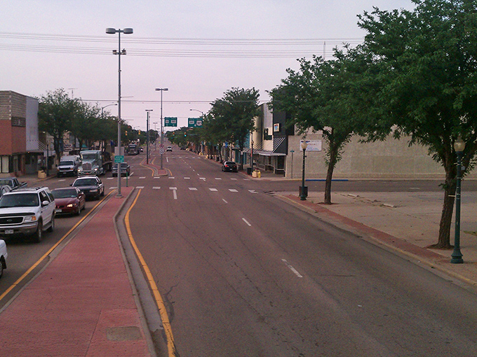 A peaceful morning in downtown Lamar, where tree-lined streets and friendly faces welcome travelers to explore this inviting Colorado town.