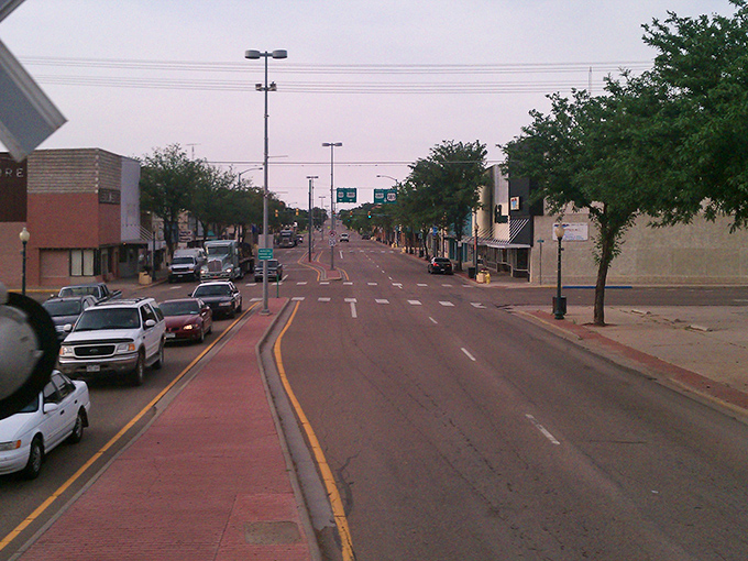 Pink-tinged twilight settles over main streets where evening drives remain affordable family entertainment options.