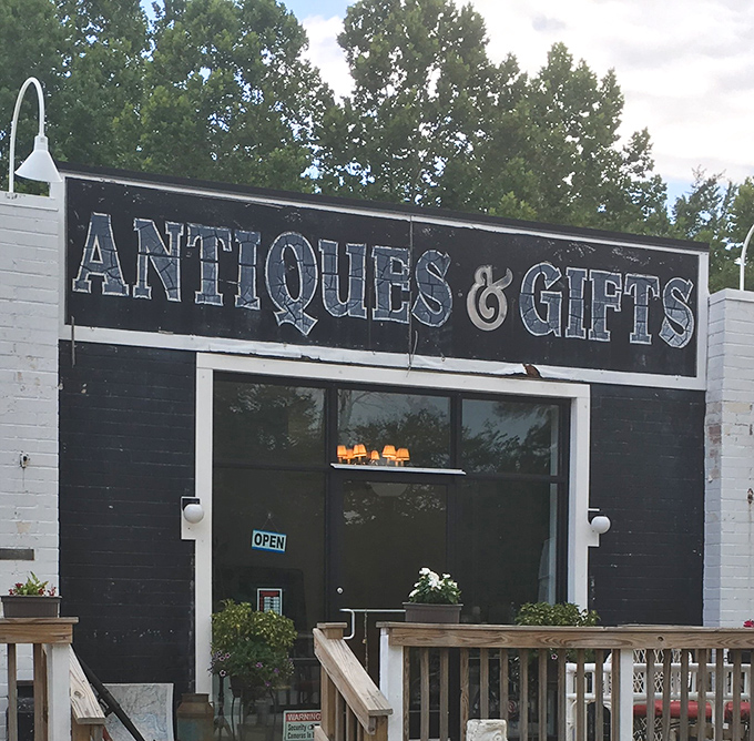 "Antiques & Gifts" &ndash; a simple black and white promise of treasures waiting behind this unassuming storefront.