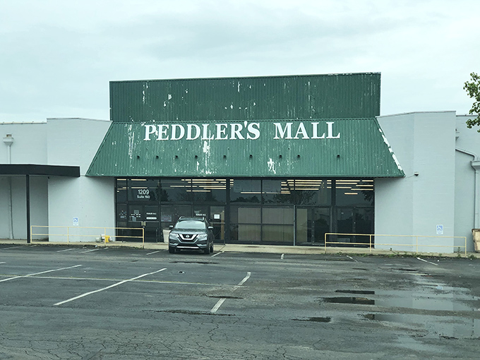 Rain-slicked pavement reflects a building where peddlers turned permanent, creating shopping stability in unpredictable times.