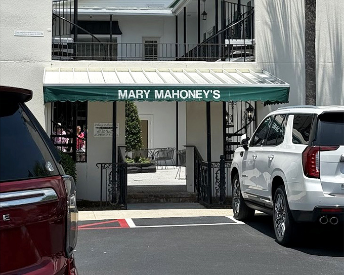 Those elegant green awnings hint at the refined dining experience waiting behind these historic French doors.