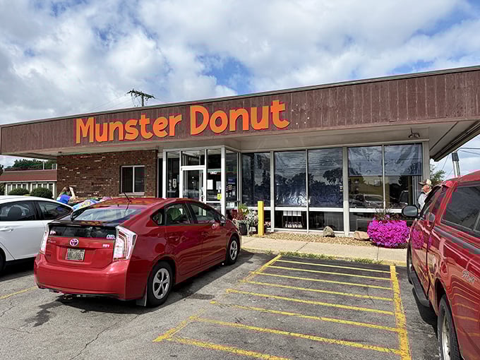 Morning light bathes Munster Donut in a golden glow. The busy parking lot tells you everything you need to know about what's inside.