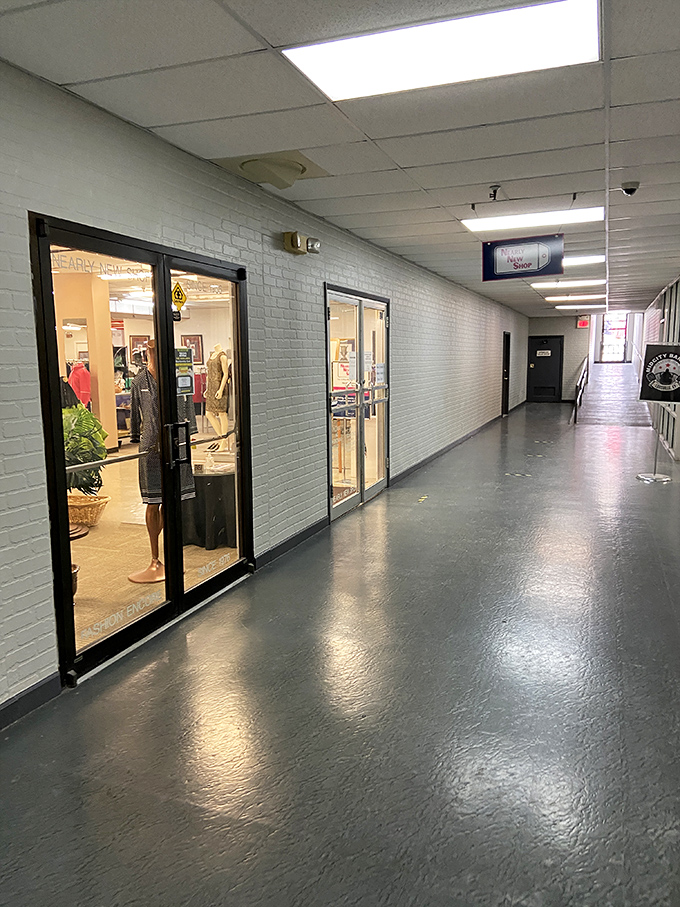 Nearly New Shop's corridor feels like the backstage pass to bargain heaven. Those glass doors reveal glimpses of treasures waiting to be discovered.