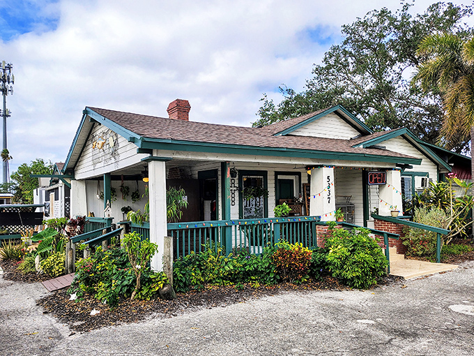 This charming cottage with teal railings doesn't just serve seafood &ndash; it serves Florida history on every plate.