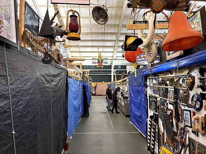 Industrial ceiling meets vintage charm as antique lanterns dangle like memories waiting to be rediscovered.
