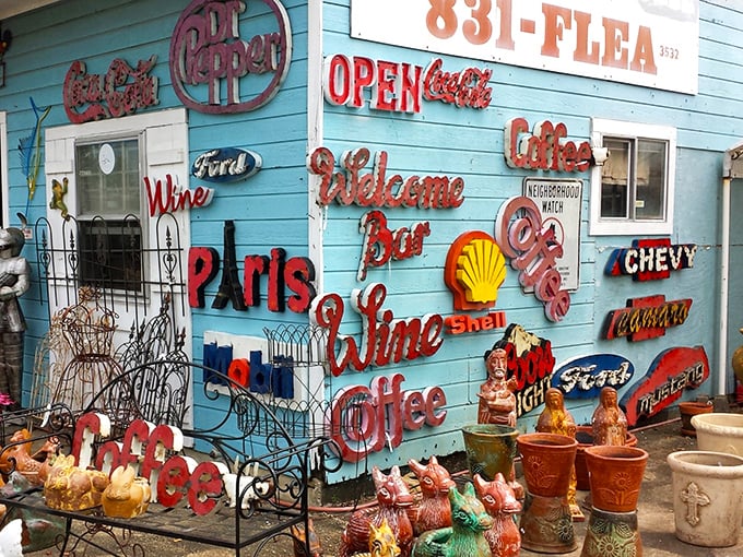 Vintage signs and garden treasures create a colorful outdoor display that screams "hidden gems ahead!"
