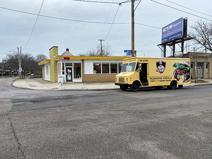 RoamingMeals' bright yellow building stands out like a culinary lighthouse. This corner spot guides the hungry to sandwich salvation.
