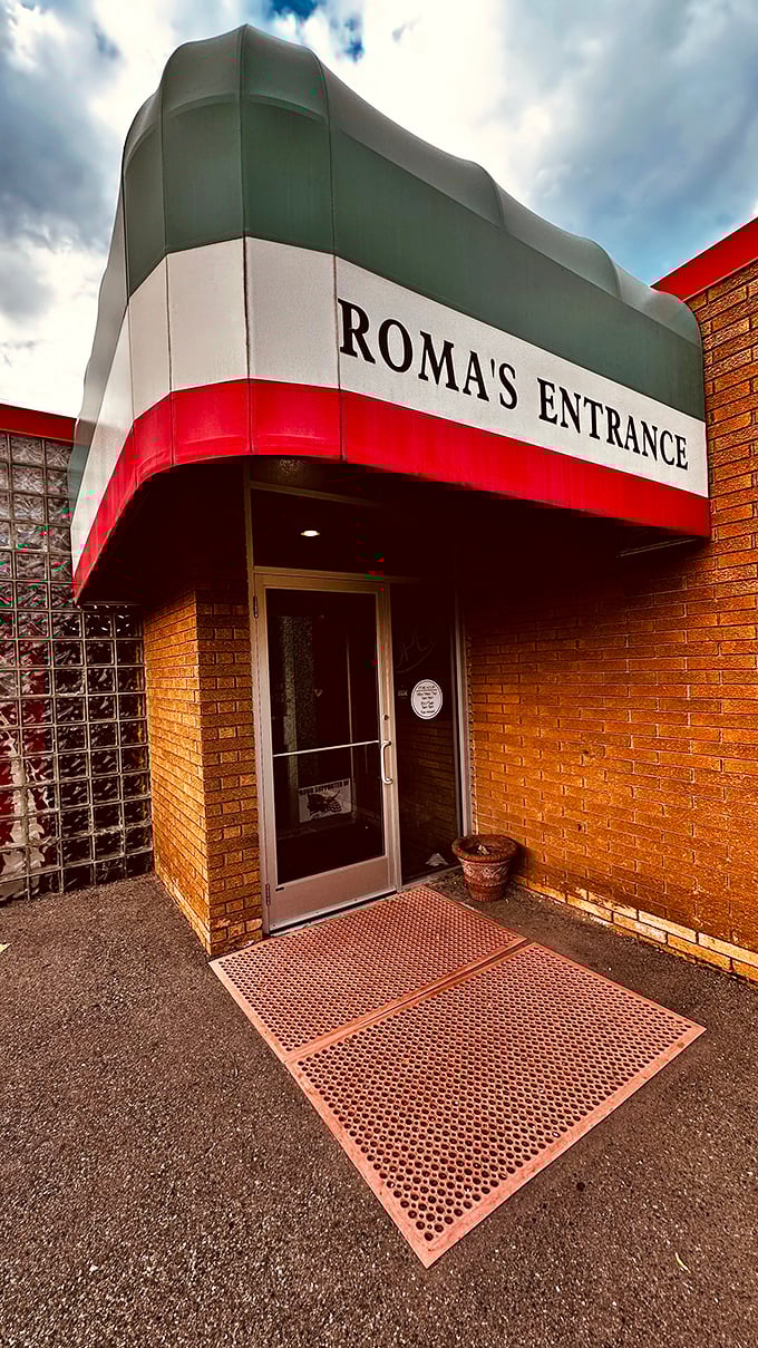 Roma's entrance proudly wears Italy's colors &ndash; a promise of authentic flavors waiting inside.