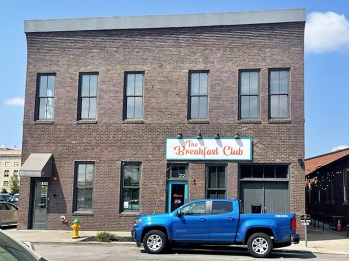 Brick building, turquoise sign, downtown charm - Des Moines breakfast done right in a space that feels like home.