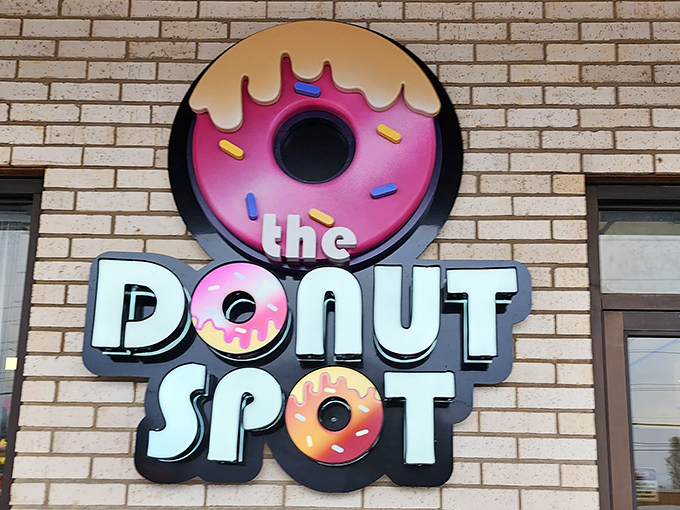 The Donut Spot's playful sign promises a circular journey to happiness, one sprinkle at a time.