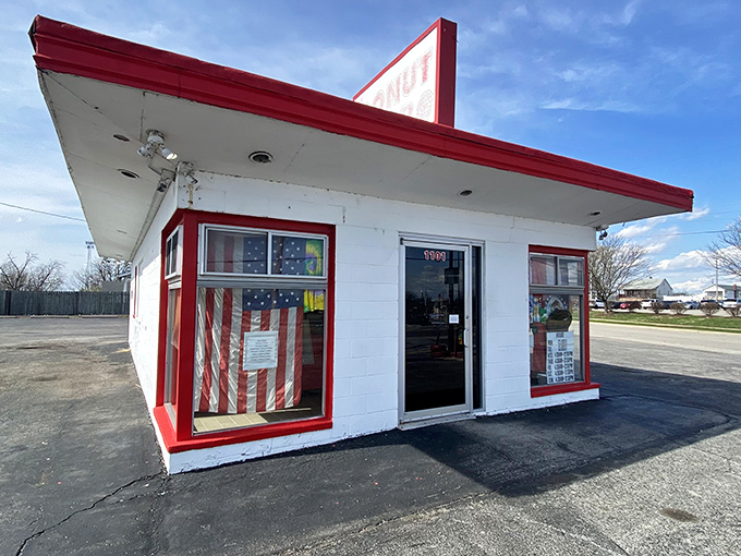 The Donut Stop's classic red and white building looks like it drove straight out of American Graffiti and into donut history.