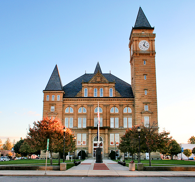 Clocktower confidence! Tipton's courthouse basks in golden-hour glory that would make Instagram influencers weep, its Romanesque grandeur practically demanding a period costume drama.